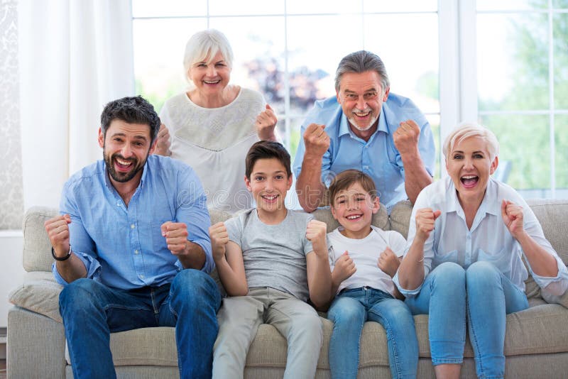 Excited family on sofa stock image. Image of elderly - 93092767