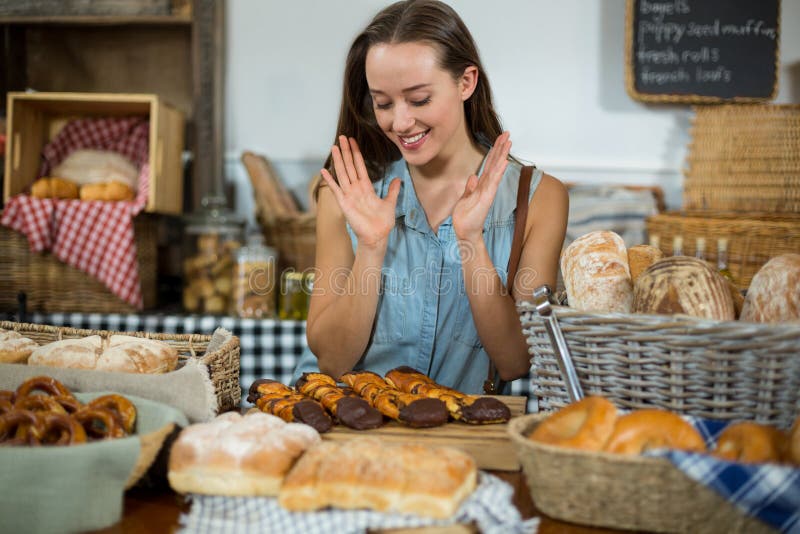 Excited Female Customer Looking at Tray of Dessert at Counter Stock ...