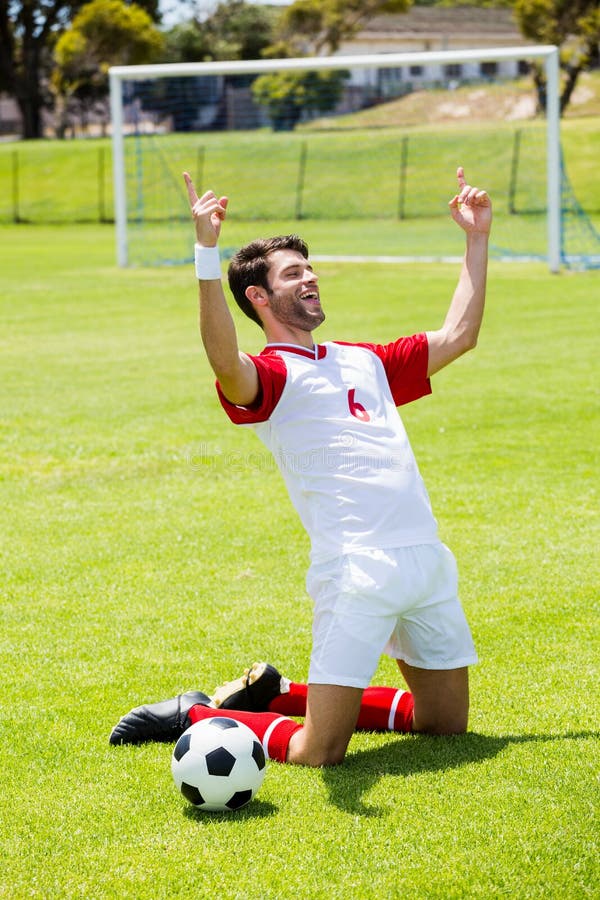Excited Football Player Kneeling in Stadium Stock Photo - Image of ...