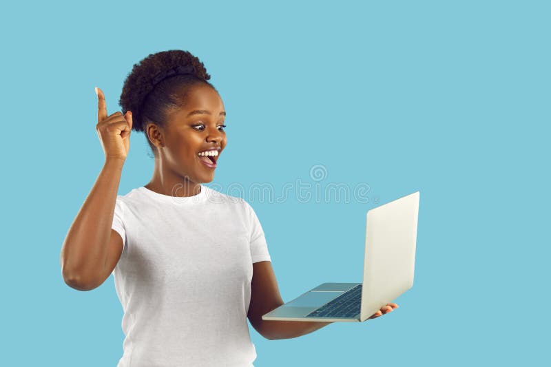 Excited Girl Pointing Index Finger Up while Looking at Laptop Computer ... Excited Girl Pointing Index Finger Up while Looking at Laptop Computer ...
