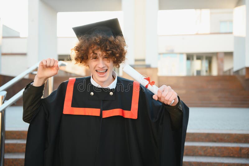 Excited Graduate Student in Gown with Risen Hands Holding Diploma ...