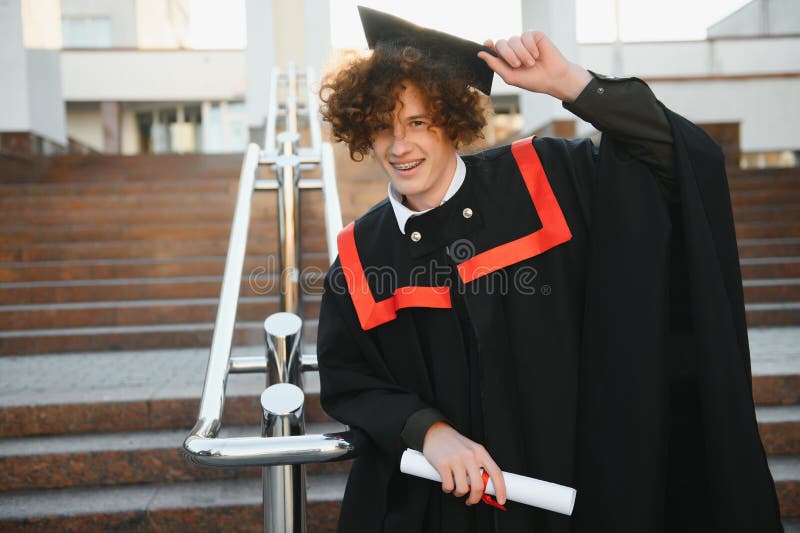 Excited Graduate Student in Gown with Risen Hands Holding Diploma ...