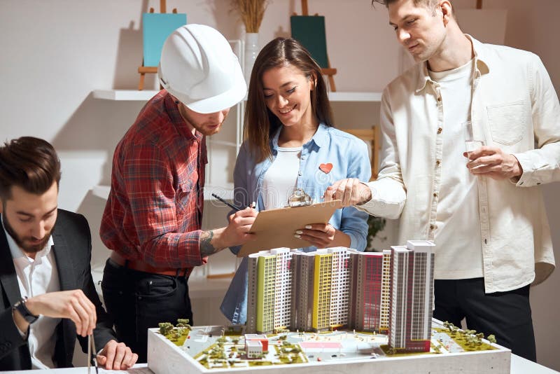 Excited Group of Young Architects Collaborating on Common Project Stock ...