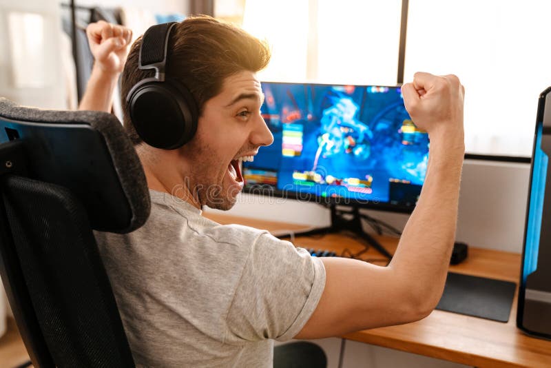 Excited Guy Making Winner Gesture while Playing Video Game on Computer ...