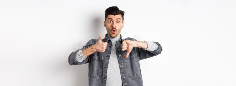 Excited Guy Show Thumbs Up and Down Judging and Making Decision, Rate ...