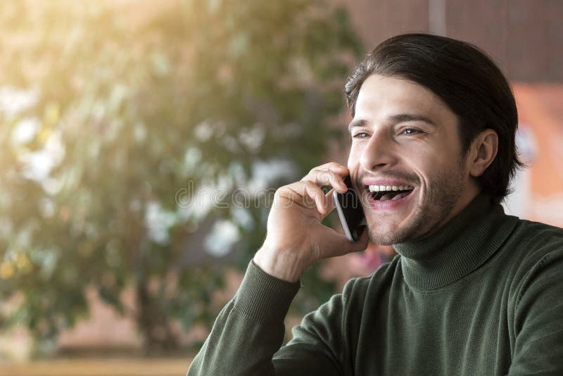 Excited Guy Talking on Smartphone and Drinking Coffee at Cafeteria Stock Photo - Image of cafe ...