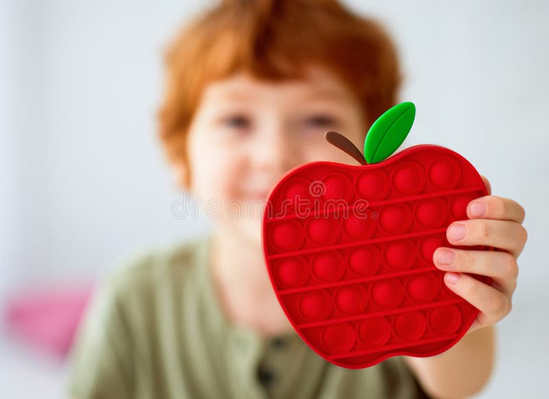 Excited Happy Kid Holding a Vibrant Sensory Toy, Pop it Fidget Toy in ...