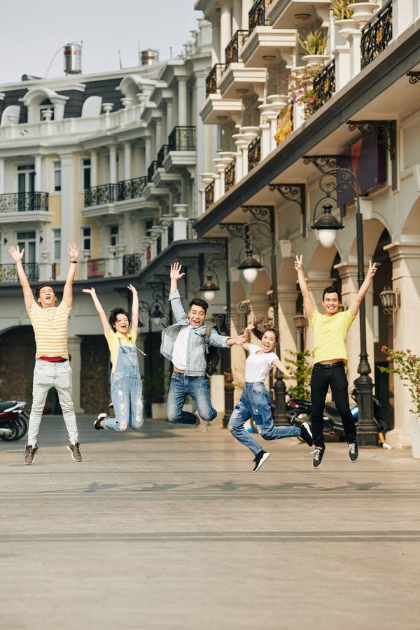 Excited Jumping Young People Stock Photo - Image of positive, asian ...