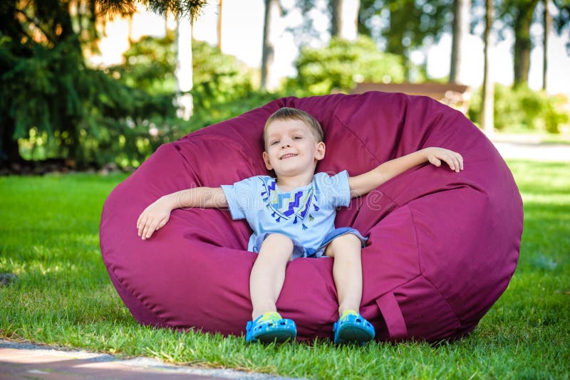 Excited Kid Having Fun on Bean Bag at Summer or Sping Park Outdoors ...