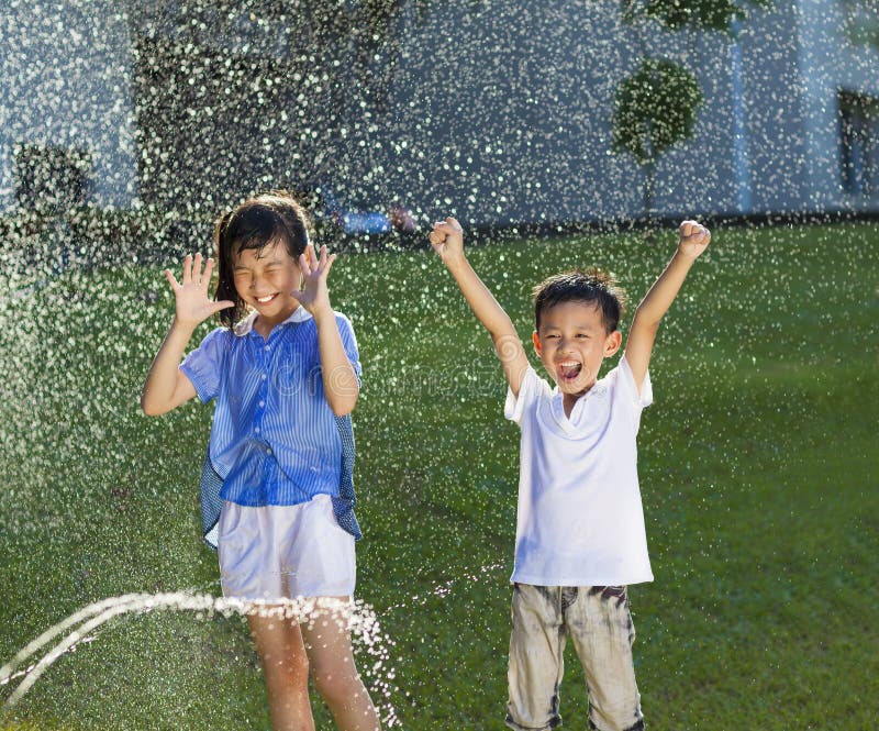 Excited Kids Has Fun Playing in Water Fountain Stock Image - Image of ...