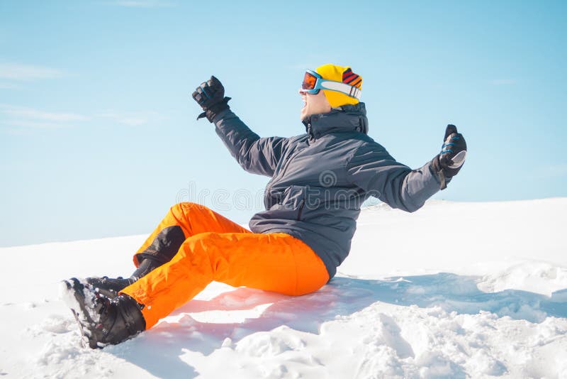 Excited Male Skier Sitting on Snow Stock Photo - Image of freedom ...