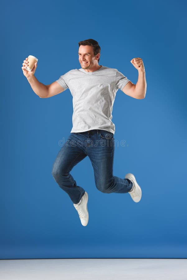 Excited Man with Coffee To Go Jumping and Triumphing Stock Photo ...