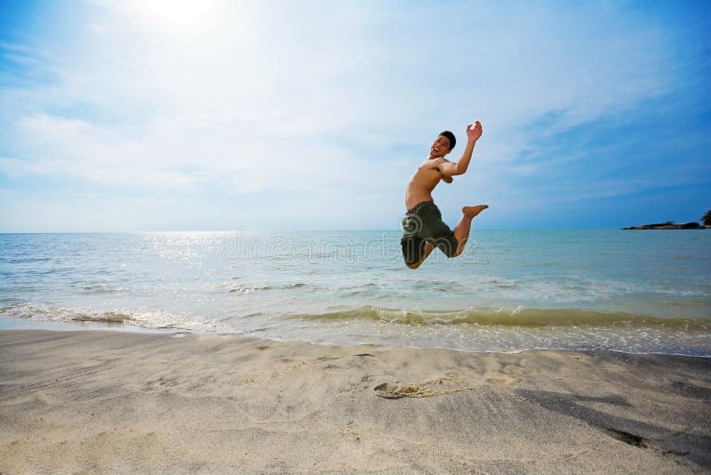 Excited man jumping stock photo. Image of beautiful, tropical - 4569088