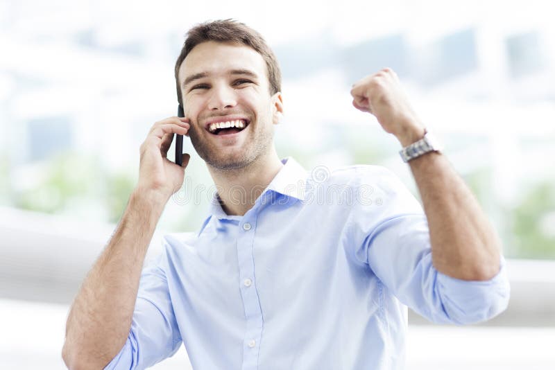 Excited Man with Mobile Phone Stock Image - Image of office, clenching ...