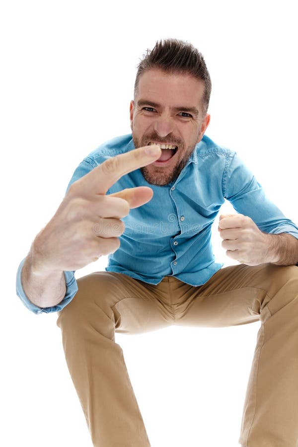 Excited Man Smiling and Screaming while Pointing Finger To Side Stock ...