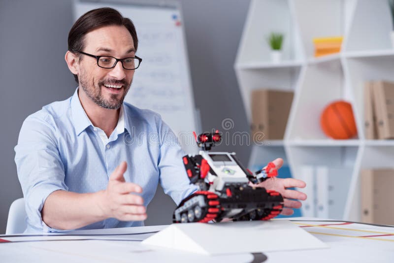 Excited Man Testing a Little Red Robot Stock Image - Image of office ...