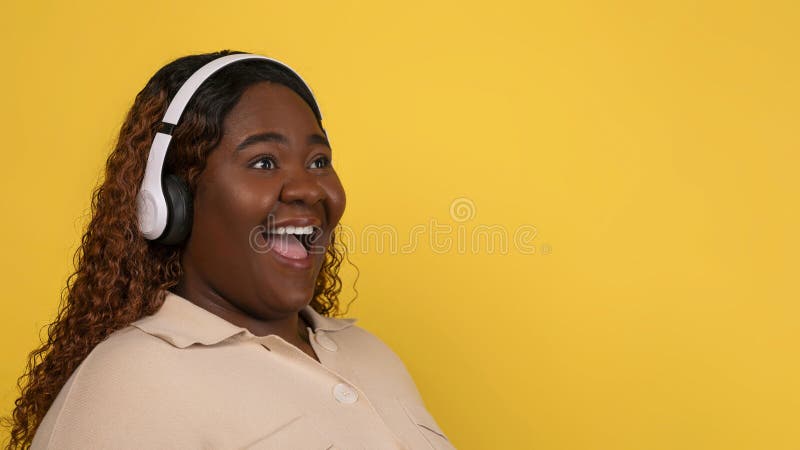 Excited Millennial Black Woman With Wireless Headphones Stock Image