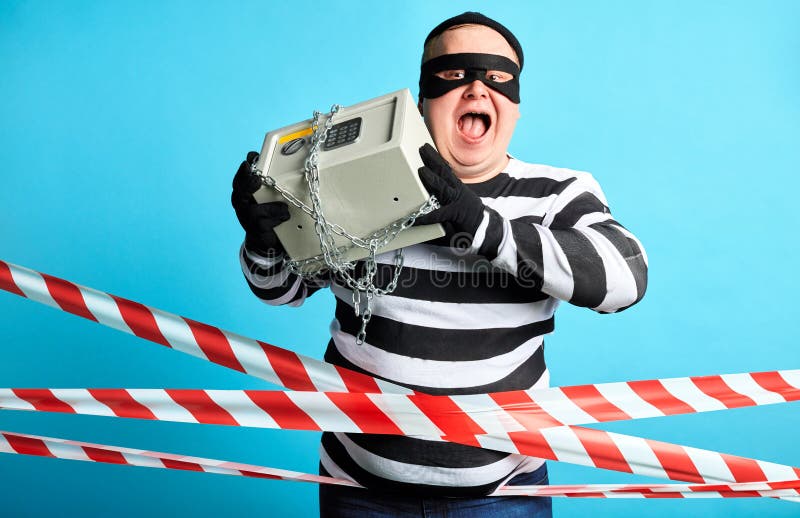 Prisoner in Mask with Chain Around His Body Standing Over Yellow ...