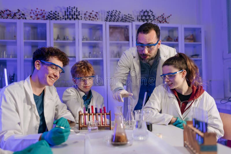 Excited Science Students with Teacher Doing Chemical Experiment in the ...