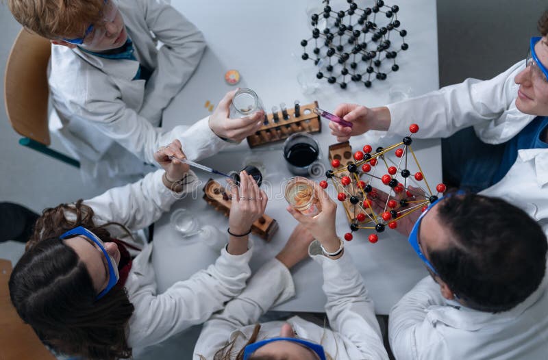 Excited Science Students Doing Chemical Experiment in the Laboratory at ...