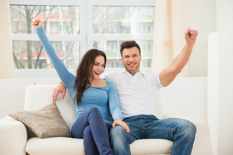 Excited smiling couple stock image. Image of home, fist - 55337197