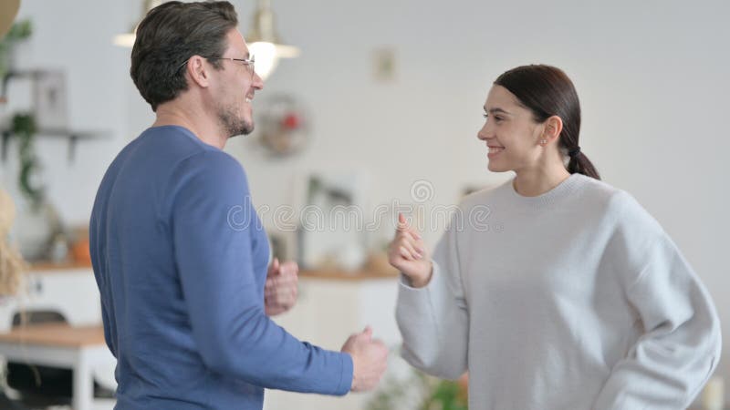 Excited Spanish Couple Dancing Together at Home, Celebrating Stock ...