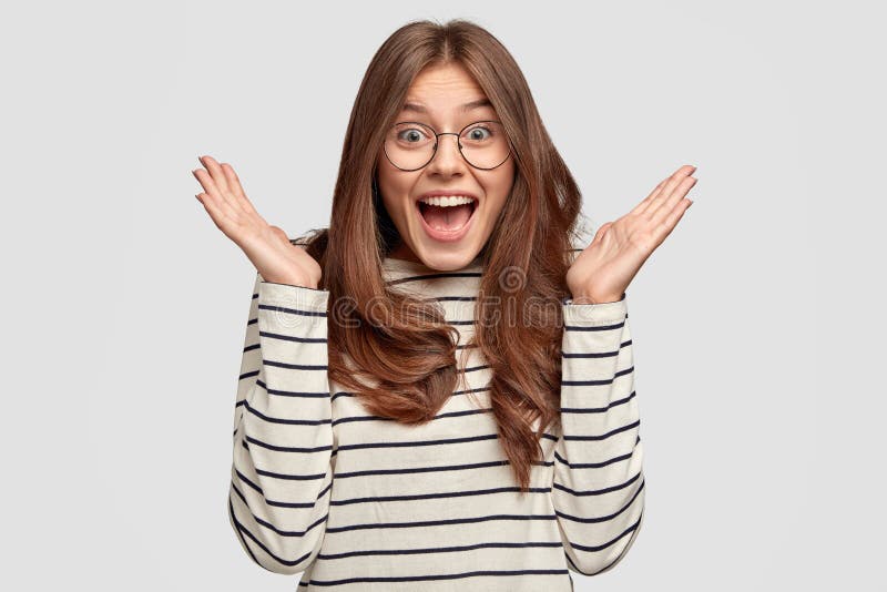 Excited Woman With Amazed Facial Expressions Keep Hands Near Face