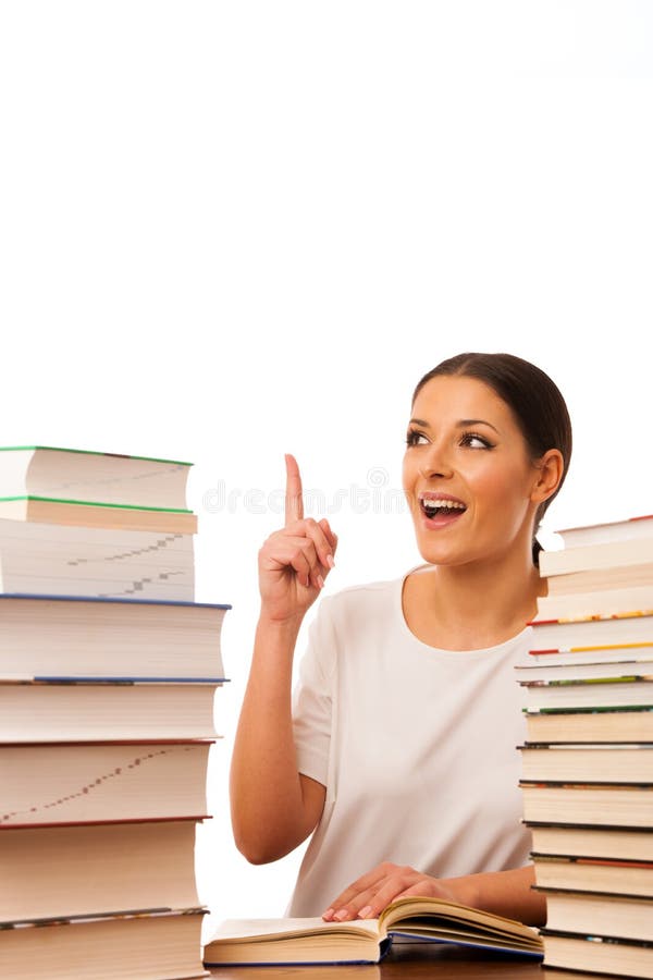 Excited Woman Reading Behind the Table between Two Pile of Books Stock ...