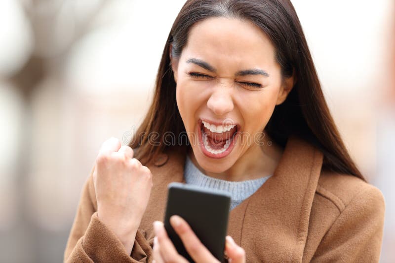 Excited Woman in Winter Checking Mobile Phone Stock Image - Image of ...