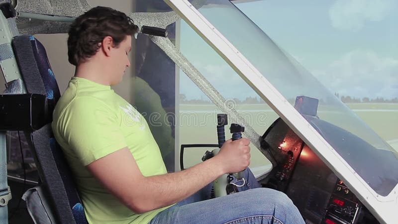 Excited Young Man Sitting in Flight Simulator, Turning Controls on ...