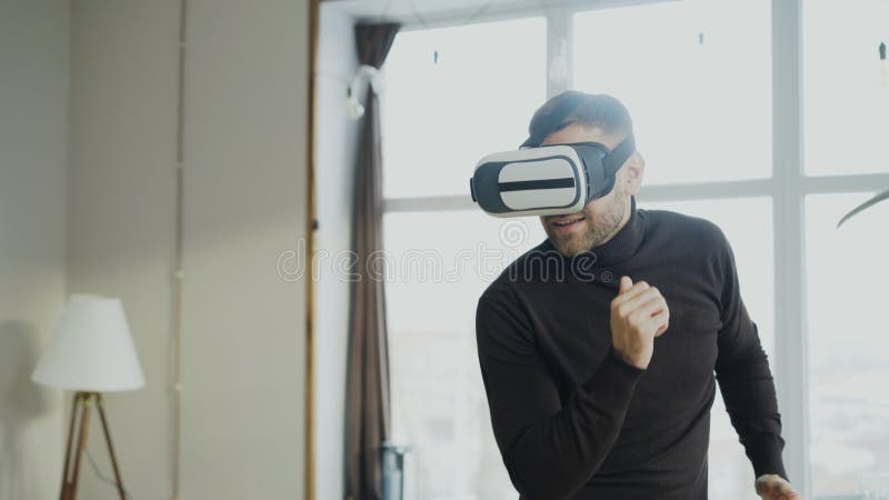 Excited Young Man with Virtual Reality Headset Dancing and Play 360 ...