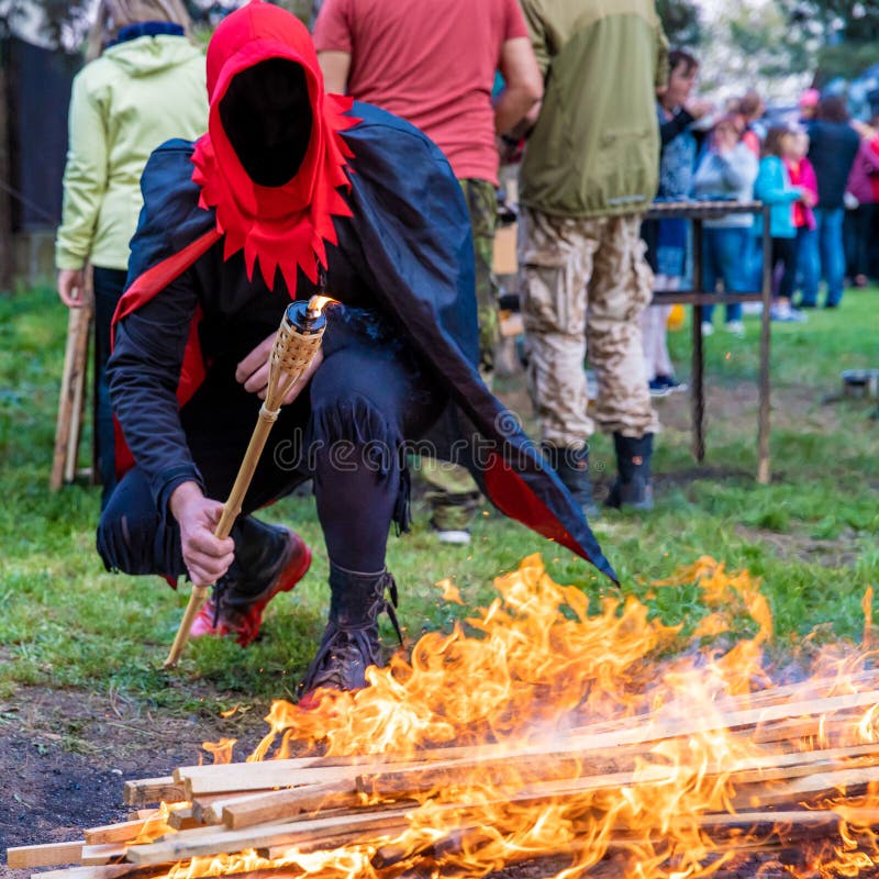 Executioner Lights a Torch by the Fire for Burning the Witch Stock ...