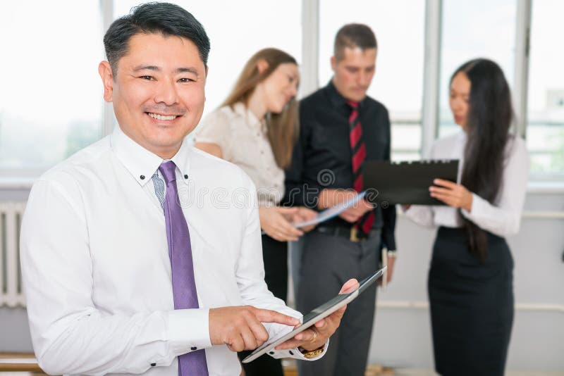 Executive Asian Boss Using Tablet Pc with His Business Team Stock Photo ...