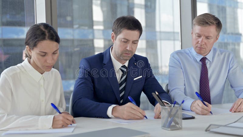 Executive Business People Writing Documents at Work Stock Image - Image ...