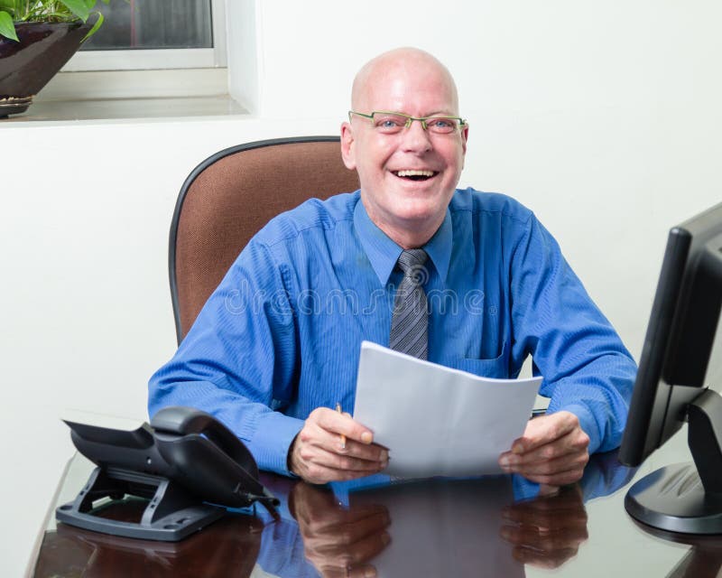 Executive at Desk Holding Papers Stock Image - Image of paperwork ...