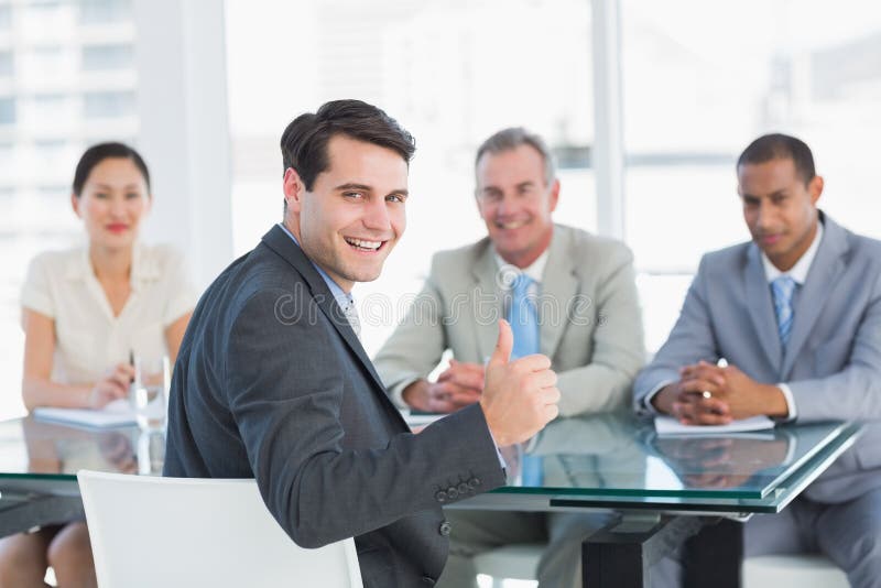 Executive Gesturing Thumbs Up with Recruiters during Job Interview ...