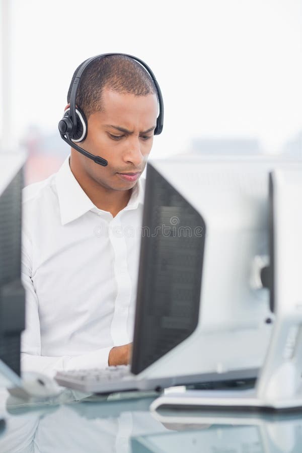 Executive with Headset Using Computer at Desk Stock Image - Image of ...