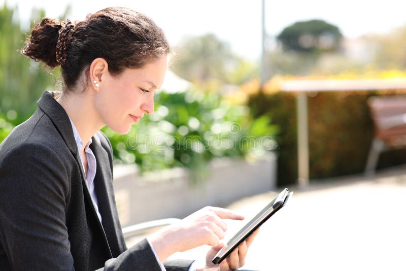 Executive Sitting in a Park Using Tablet Stock Photo - Image of ...