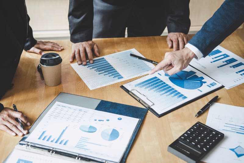 Executive Team Discussing the Charts and Graphs Working in Business ...