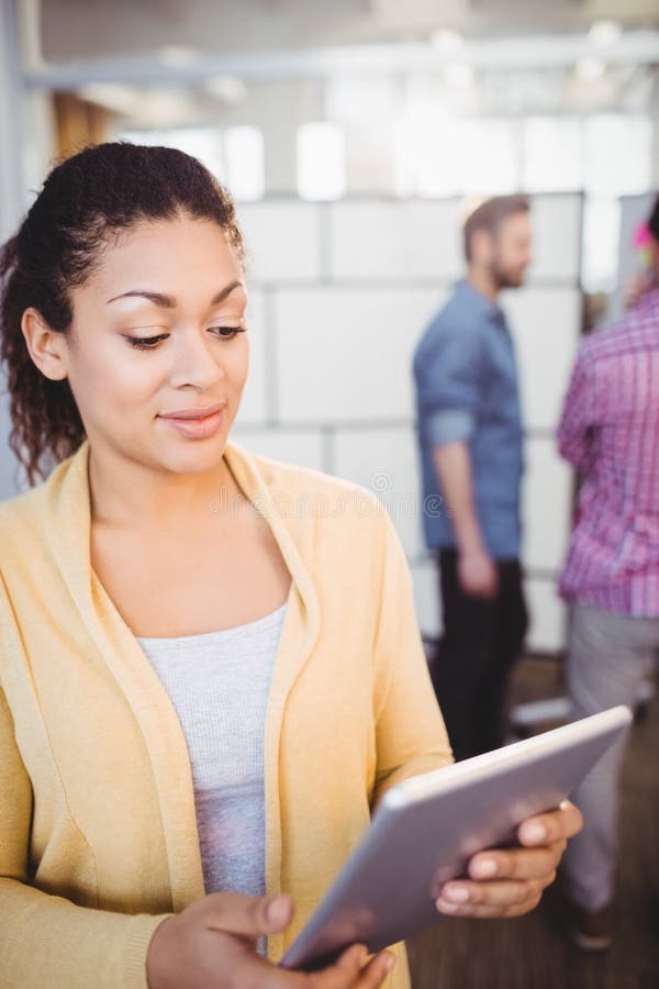 Executive Using Digital Tablet at Creative Office Stock Photo - Image ...