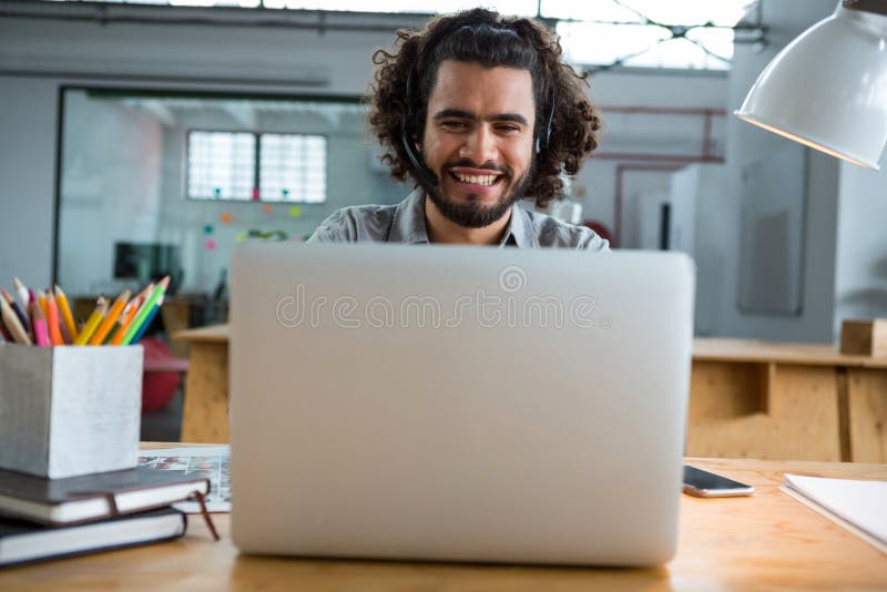 Executive Using Laptop in Creative Office Stock Image - Image of desk ...
