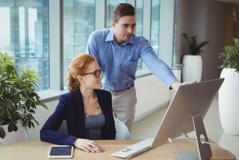 Executives Having Discussion Over Personal Computer at Desk Stock Image ...