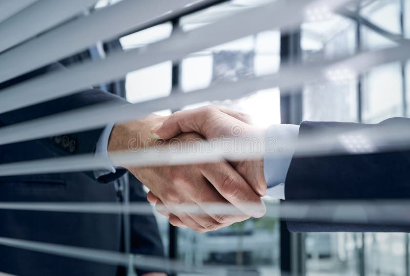 Executives Shaking Hands in Front of Their Manager and a Colleague ...