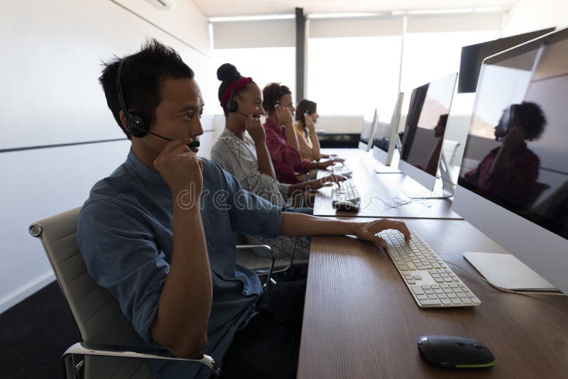 Executives Talking on Headset in Office Stock Photo - Image of 2024 ...