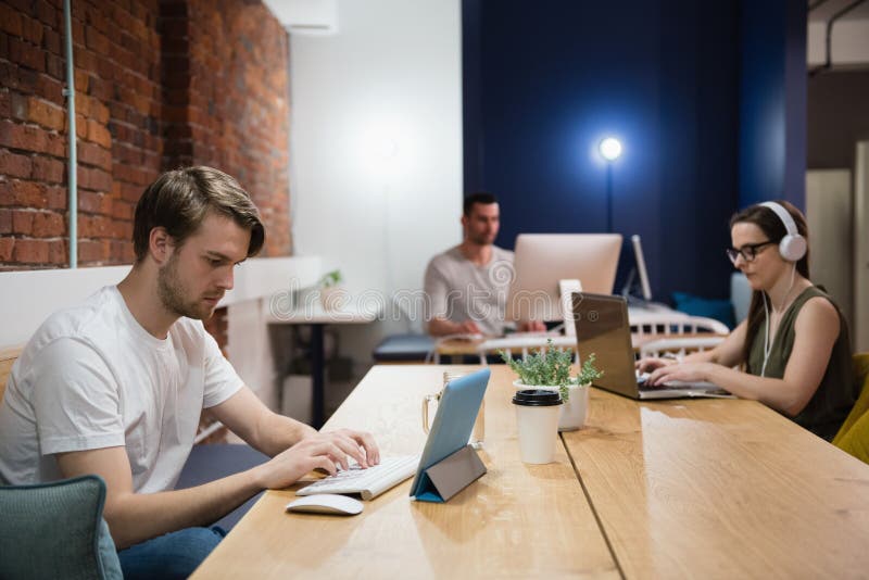 Executives Working at Desk in Office Stock Image - Image of headphones ...