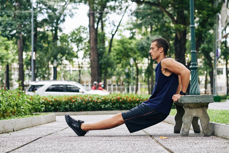 Exercising at bench stock photo. Image of exercise, park - 74854982