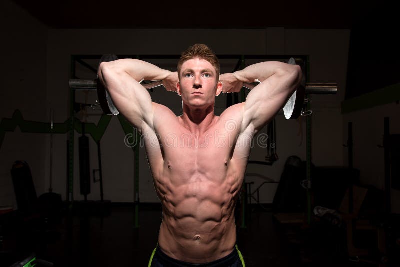 Exercising in Dramatic Light Stock Image - Image of attractive, light ...