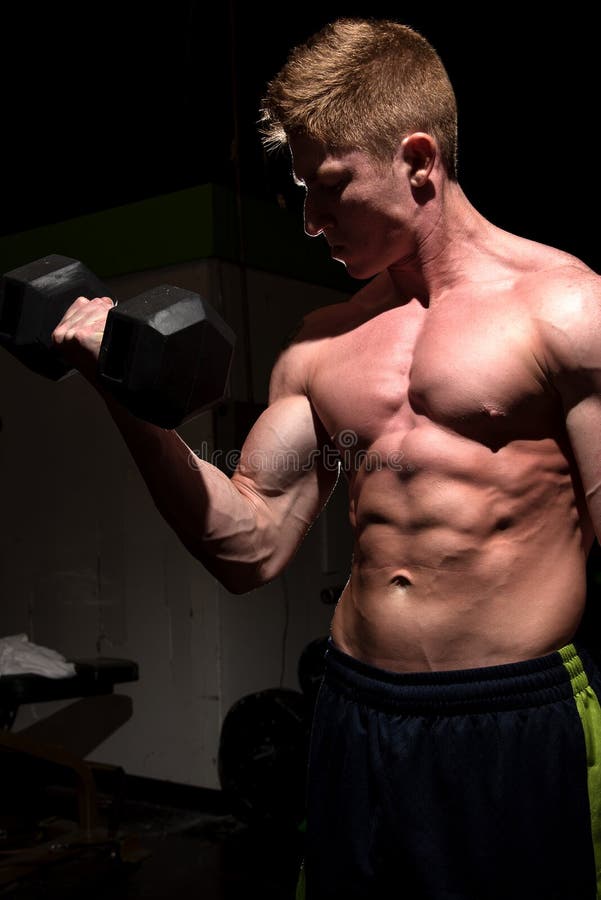 Exercising in Dramatic Light Stock Image - Image of lighting, lifting ...