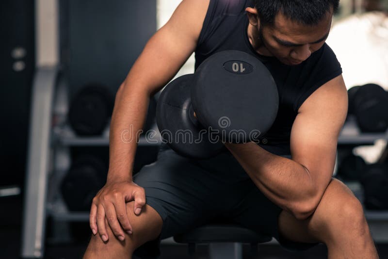 Exercising with dumbbell stock photo. Image of masculine - 58053590