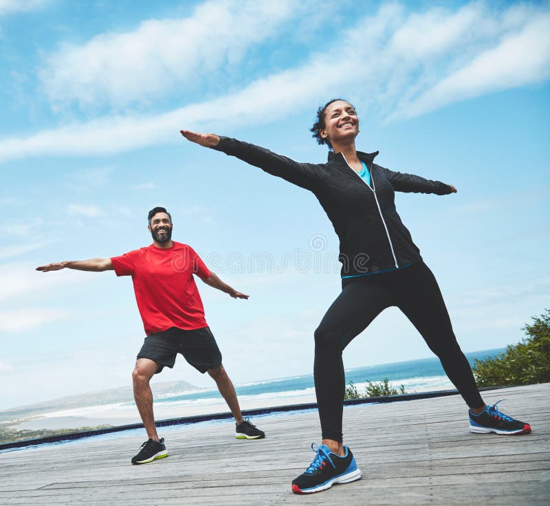 Exercising Outside Increases the Fun Factor. a Couple Doing Yoga ...